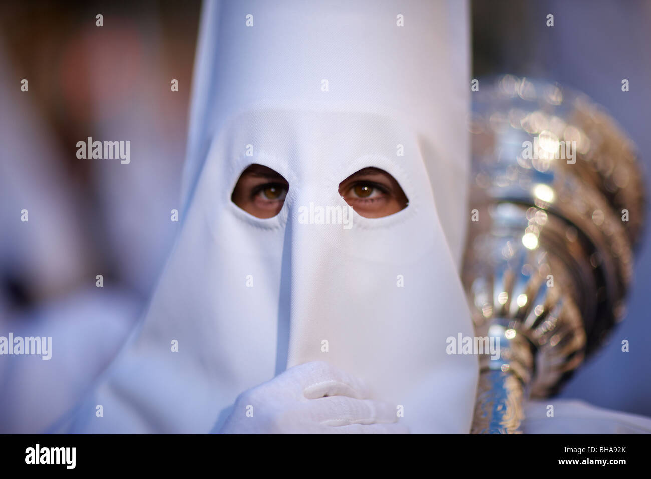 a penitent carrying a mace in the Semana Santa procession in Malaga ...