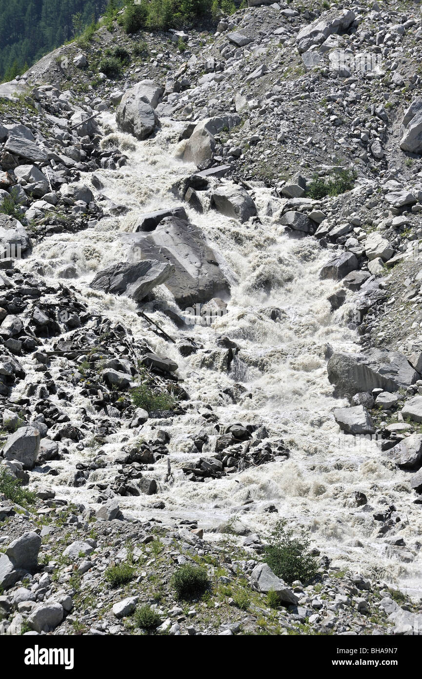 Mountain stream in the Alps with meltwater from a glacier, called ...