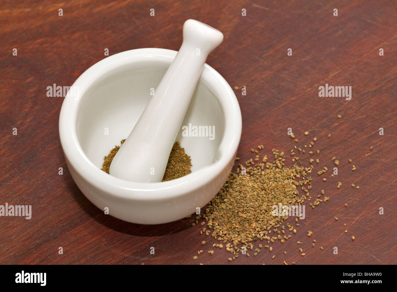 Wooden pestle is grinding herbs in a mortar hi-res stock photography ...