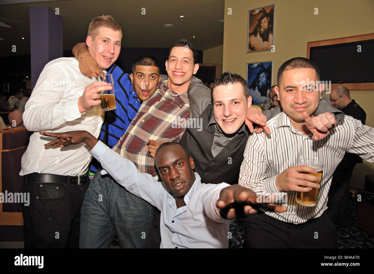 A group of young men posturing, posing for a group picture at a twenty ...