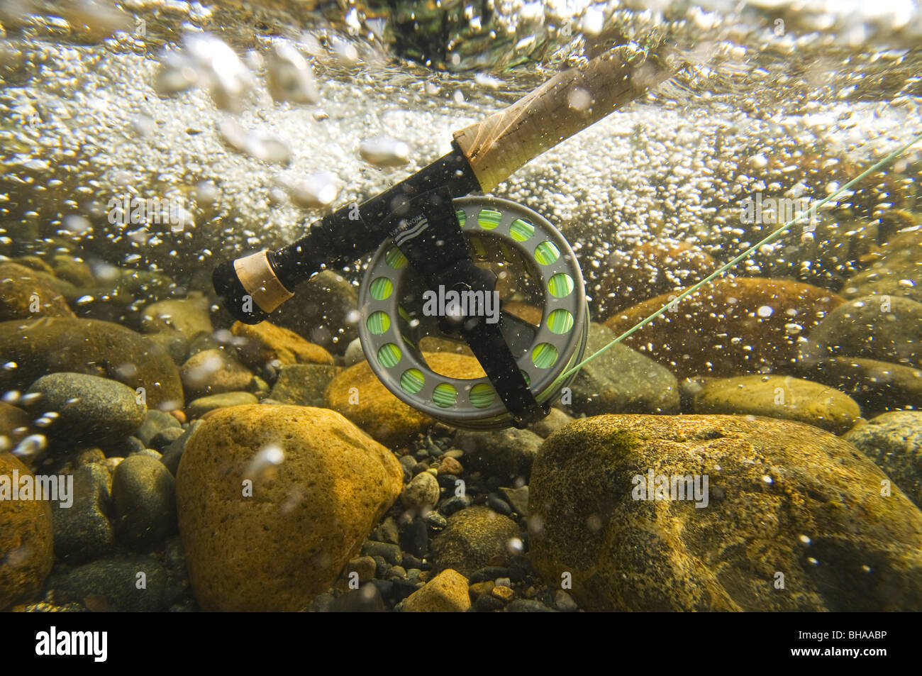 Underwater view of a fly rod and reel in the fast moving water of ...