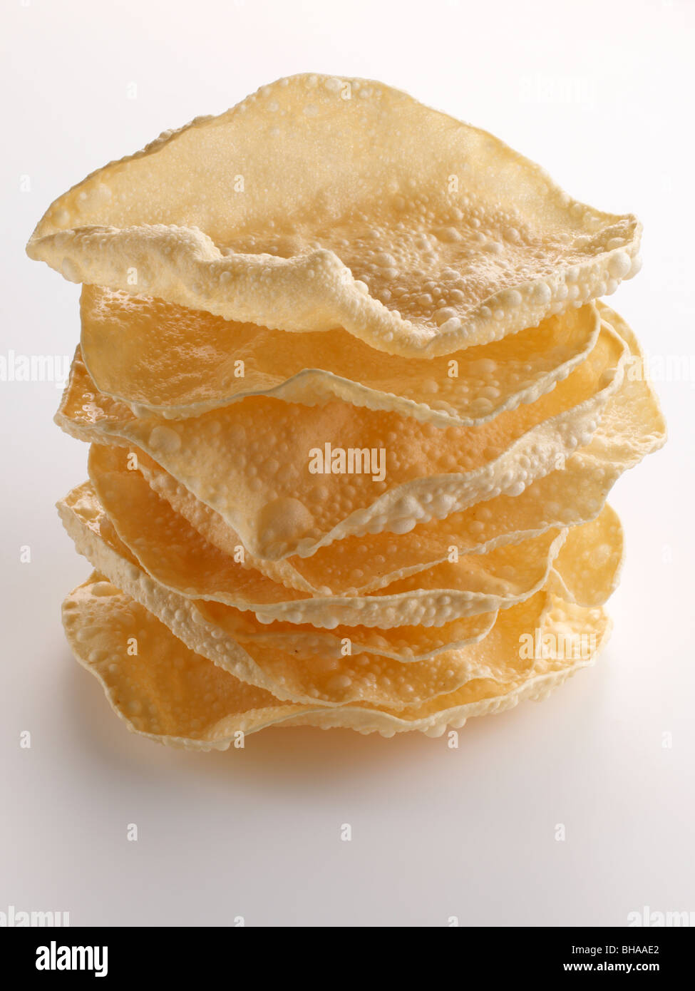 A pile of poppadoms on a white background Stock Photo - Alamy