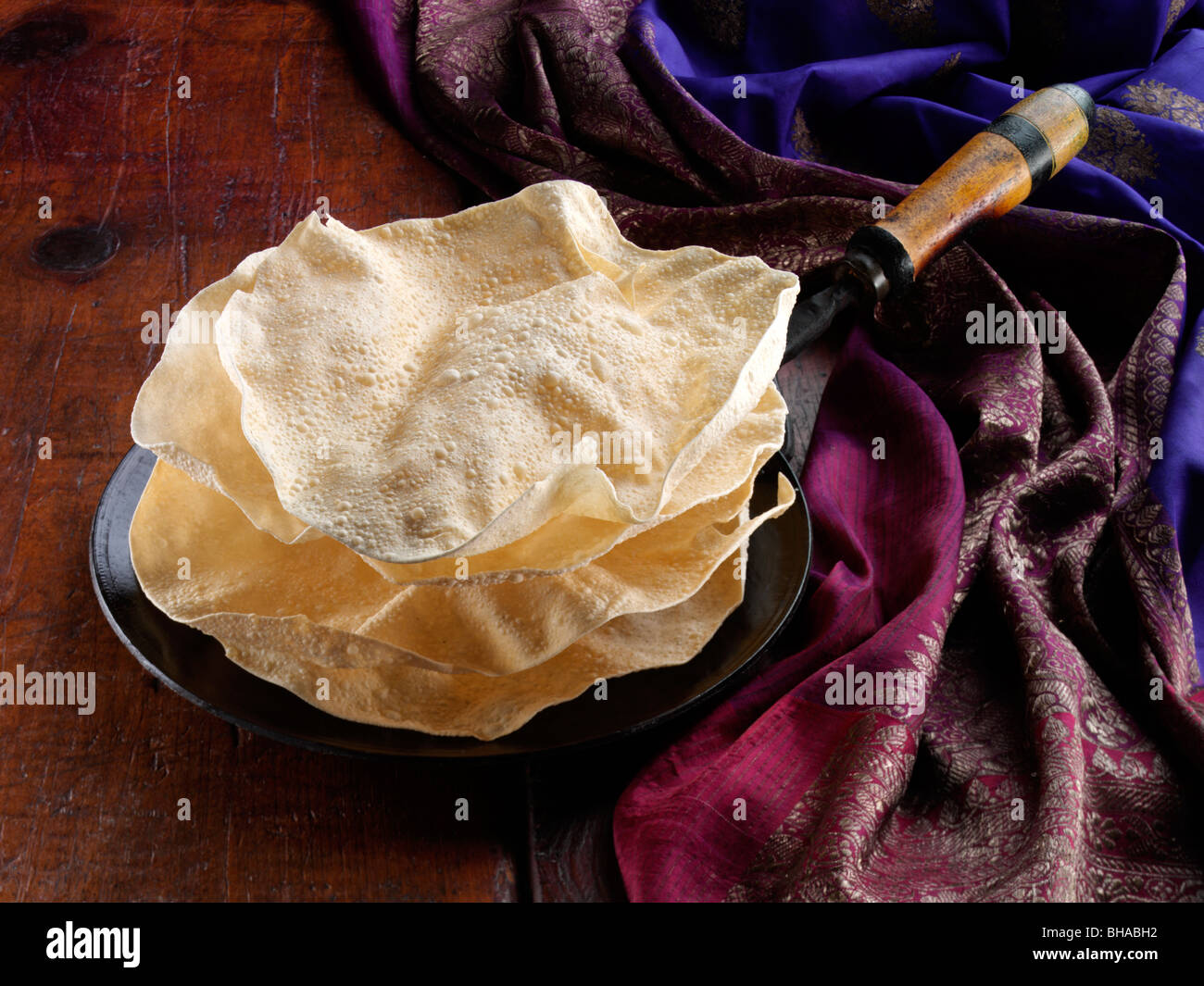 A pile of poppadoms in a rustic pan Stock Photo - Alamy