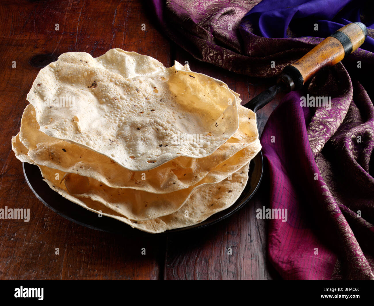 A pile of poppadoms in a rustic pan Stock Photo - Alamy