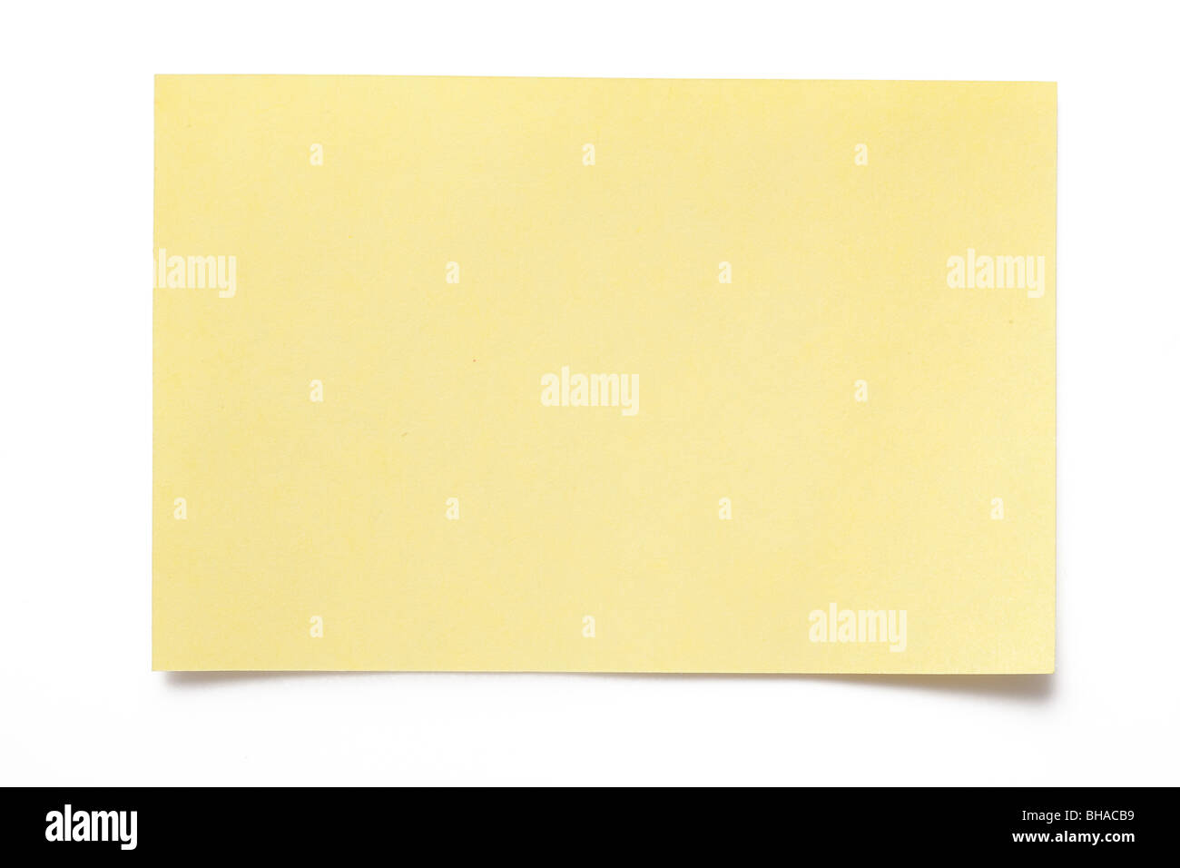 yellow note paper on white background Stock Photo - Alamy