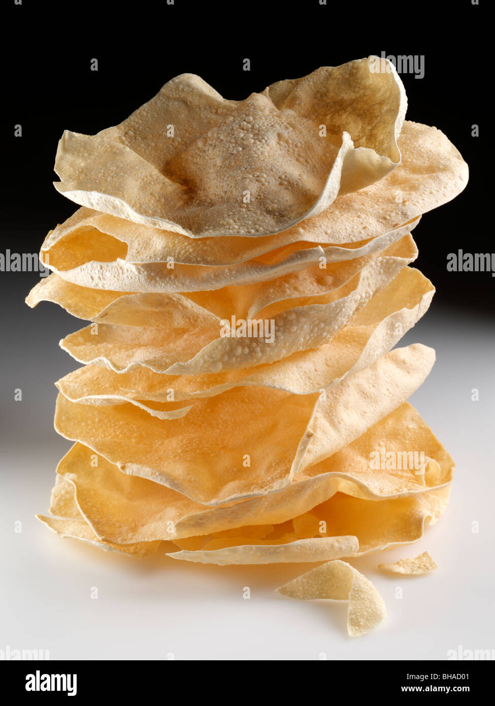 A pile of poppadoms on a white background Stock Photo - Alamy