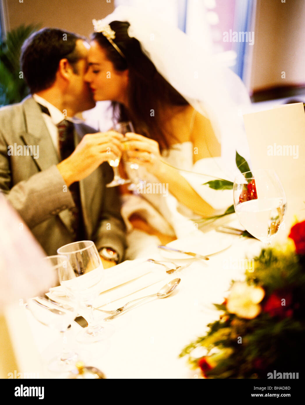 Bride & Groom at top table kissing Stock Photo - Alamy