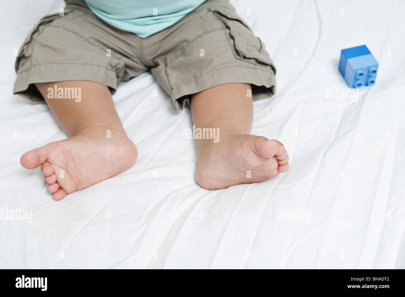Closeup of baby's feet with block toy Stock Photo - Alamy