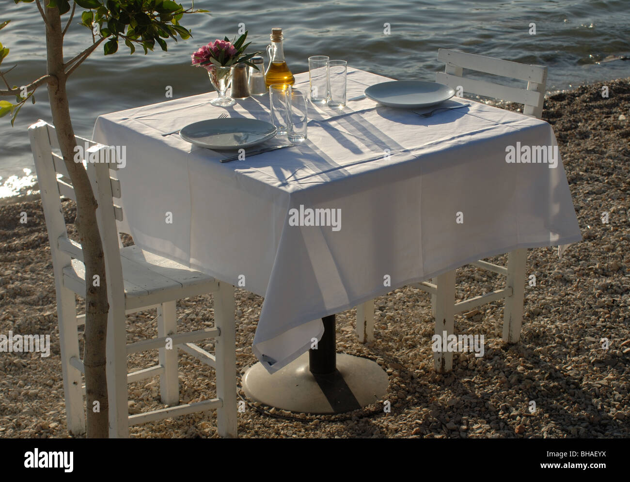 dinner table at the beach of Greek island Stock Photo - Alamy