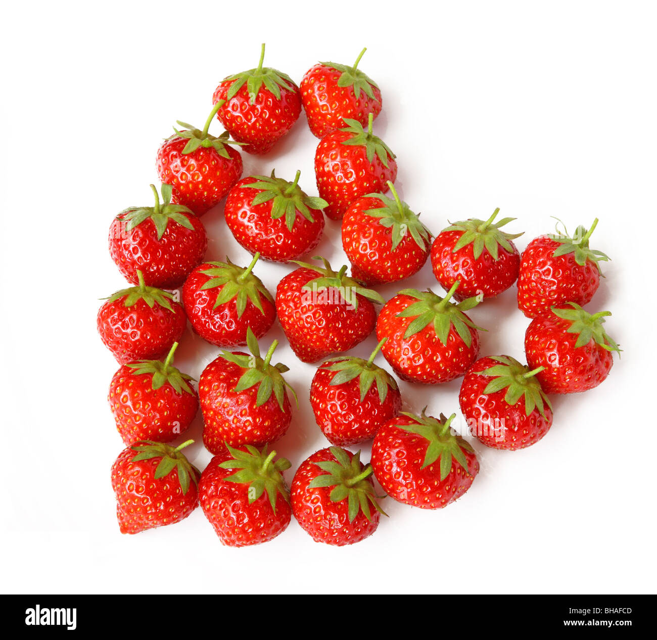 Fresh, ripe, organic strawberries placed to create a heart shape ...