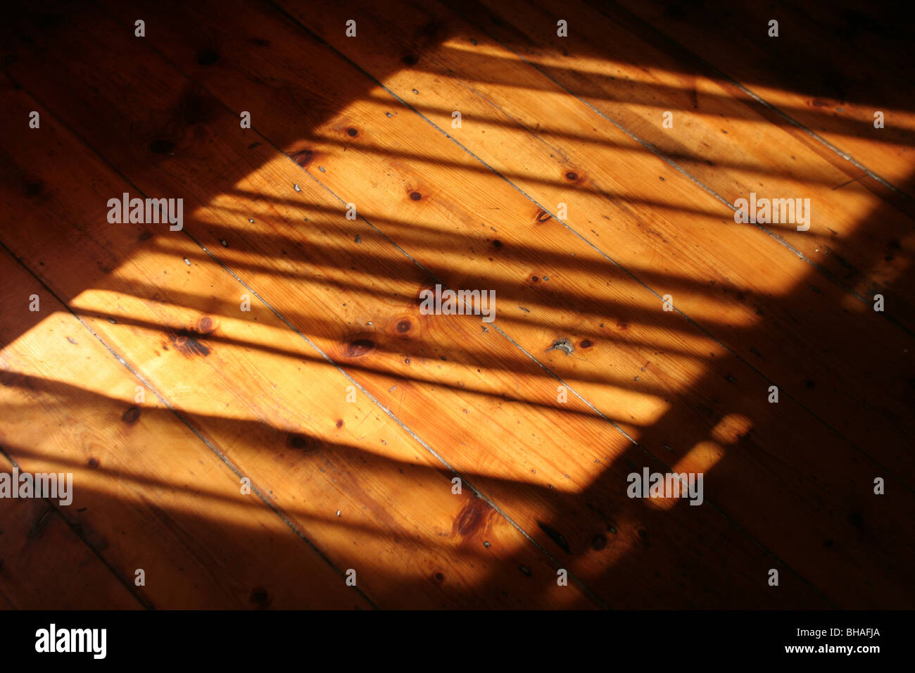 Sunlight falling on wooden polished floorboards, creating shadows Stock ...