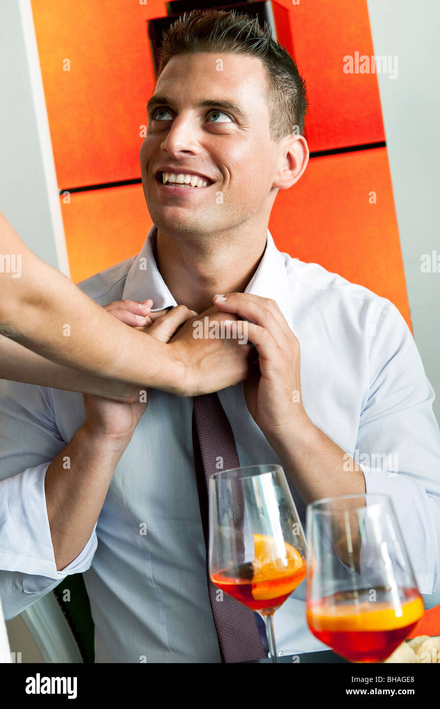 Young woman's arms adjusting young man's tie Stock Photo - Alamy