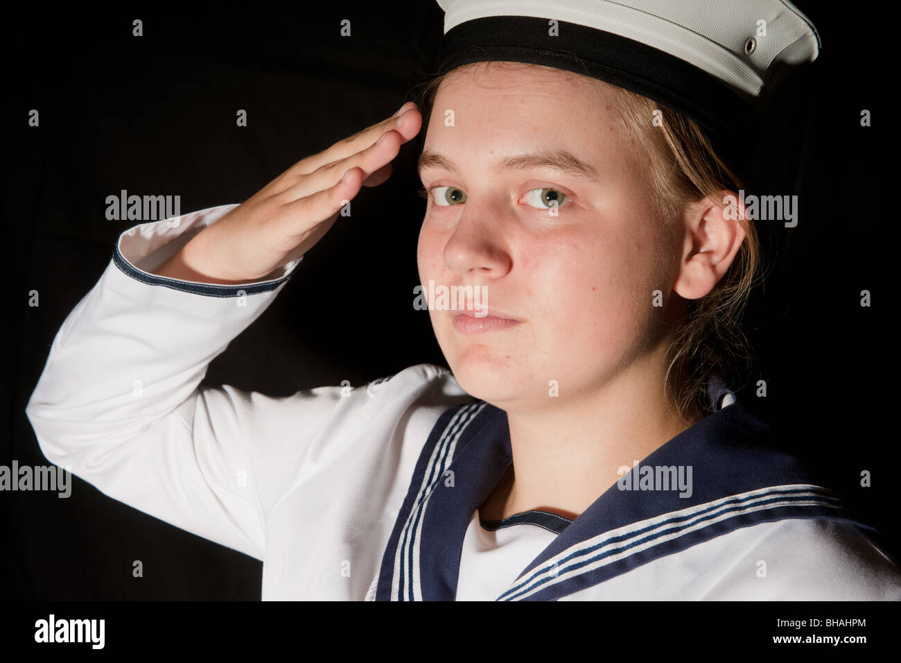 young female sailor saluting isolated on black Stock Photo - Alamy