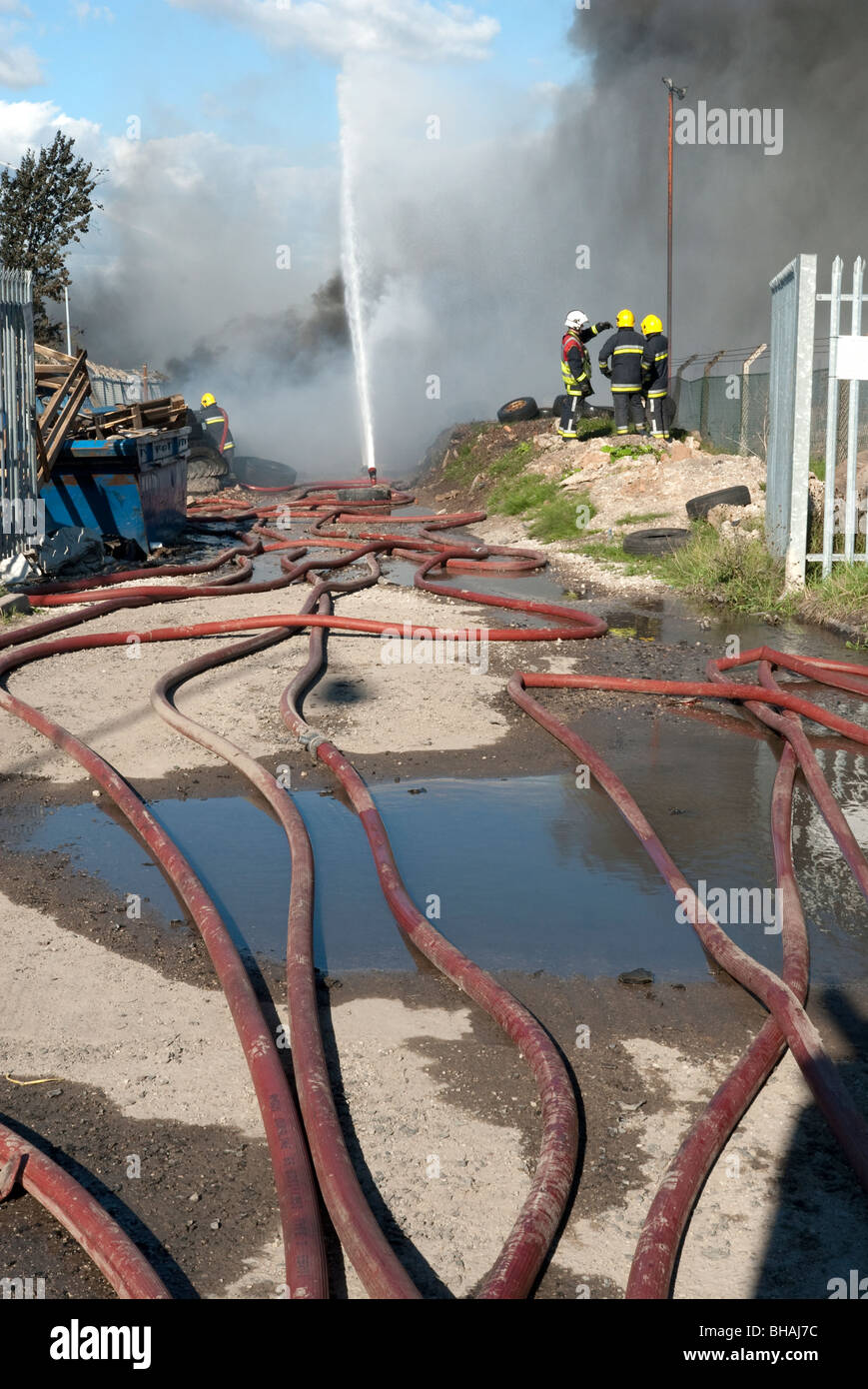 lots of fire hose at large fire Stock Photo - Alamy