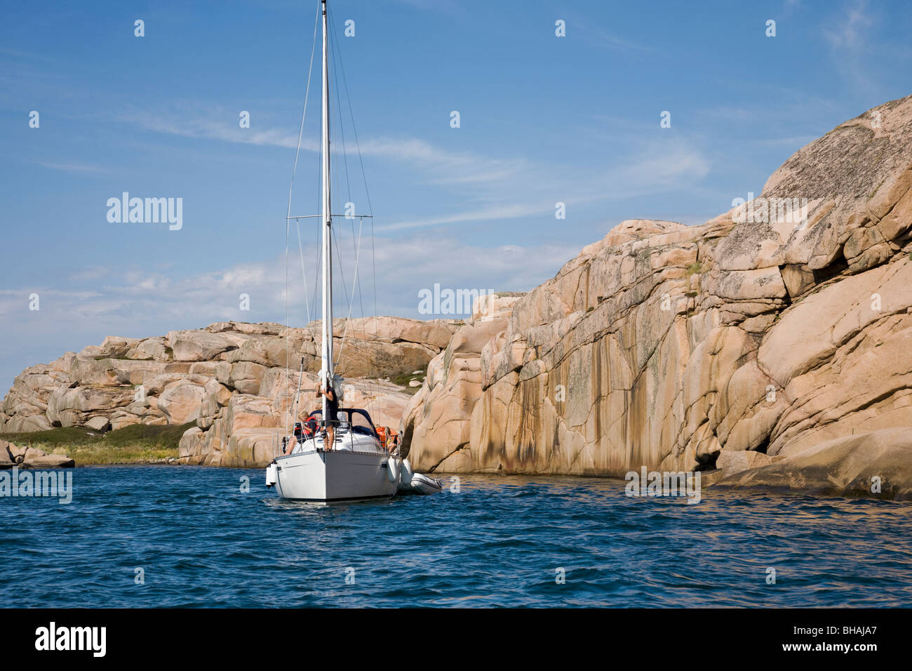 Sailboat in a bay with cliffs Stock Photo - Alamy