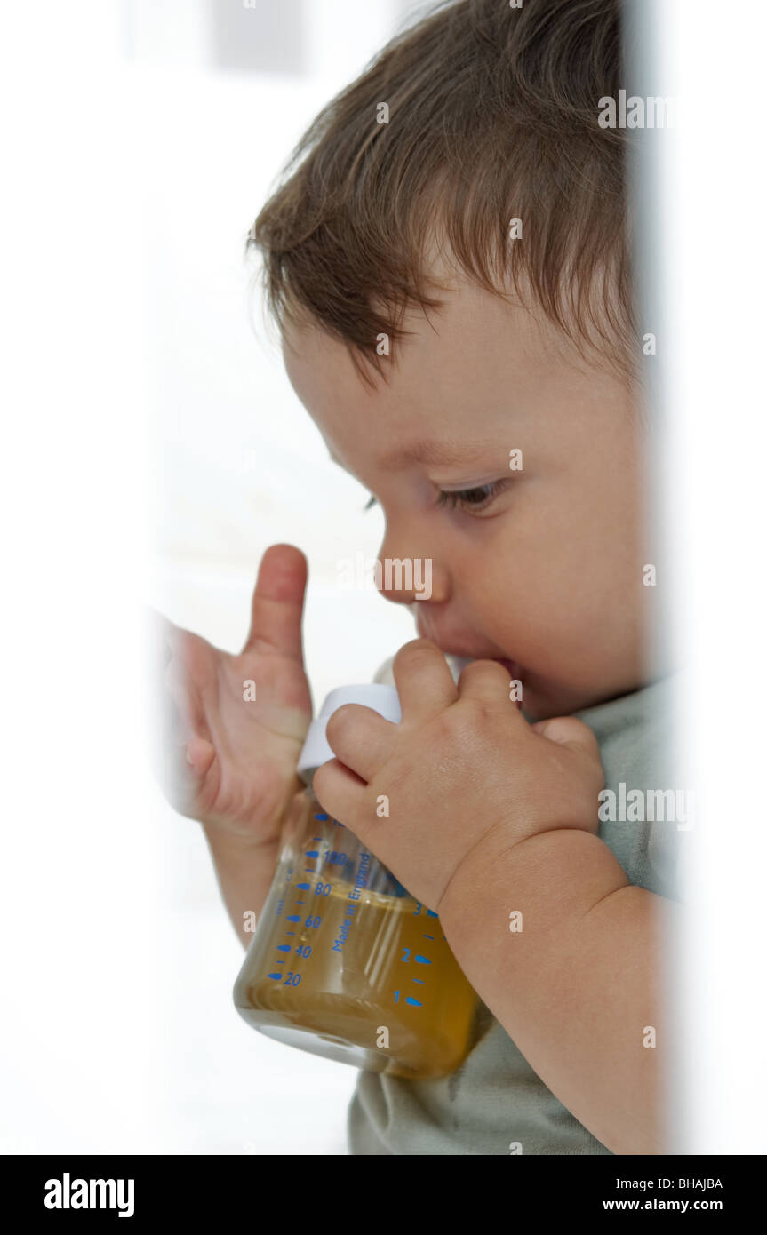 Baby boy drinking from bottle Stock Photo - Alamy