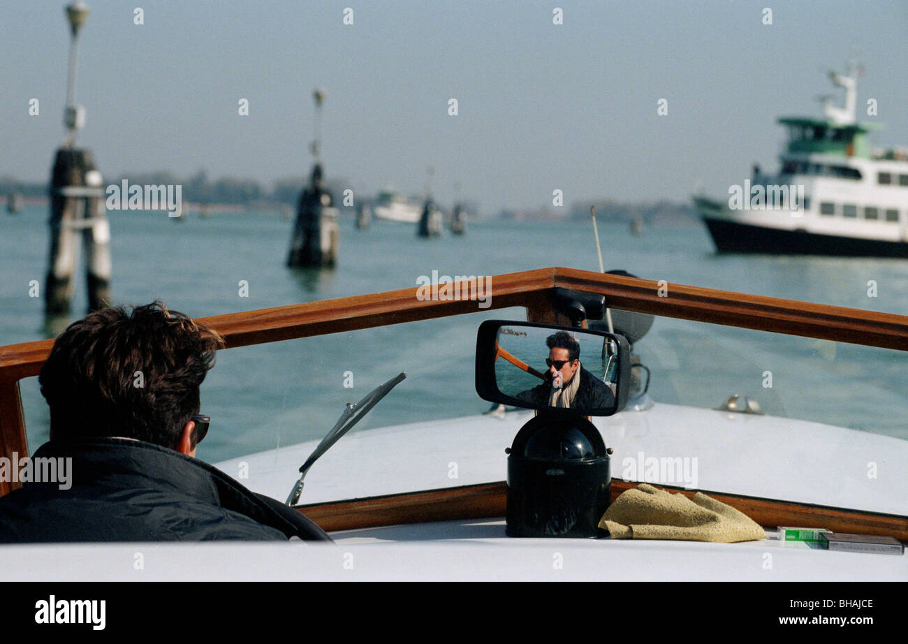 Taxi boat driver with sunglasses in Venice Italy Stock Photo - Alamy