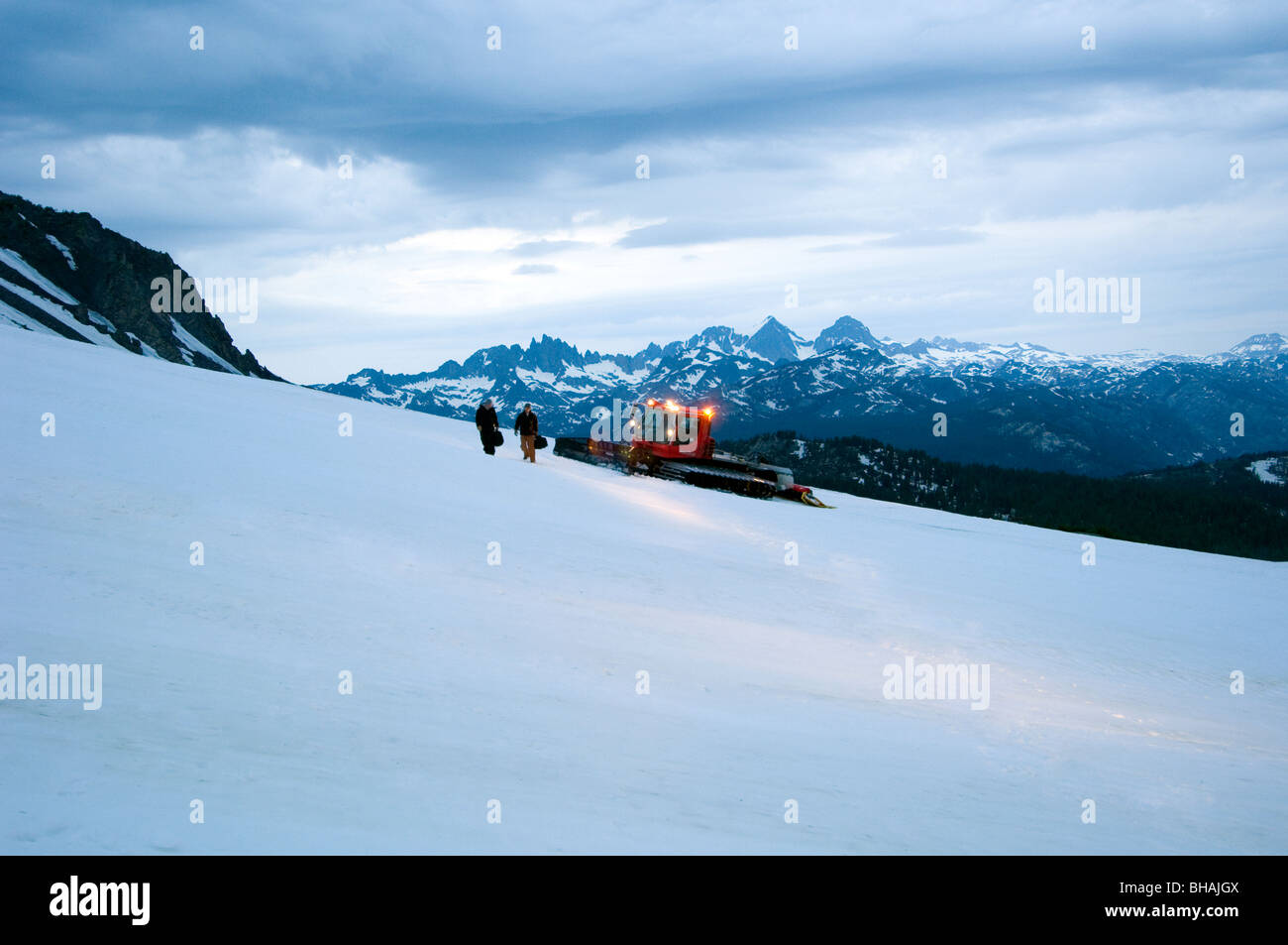 ski resort workers working around a snow grooming machine Stock Photo ...