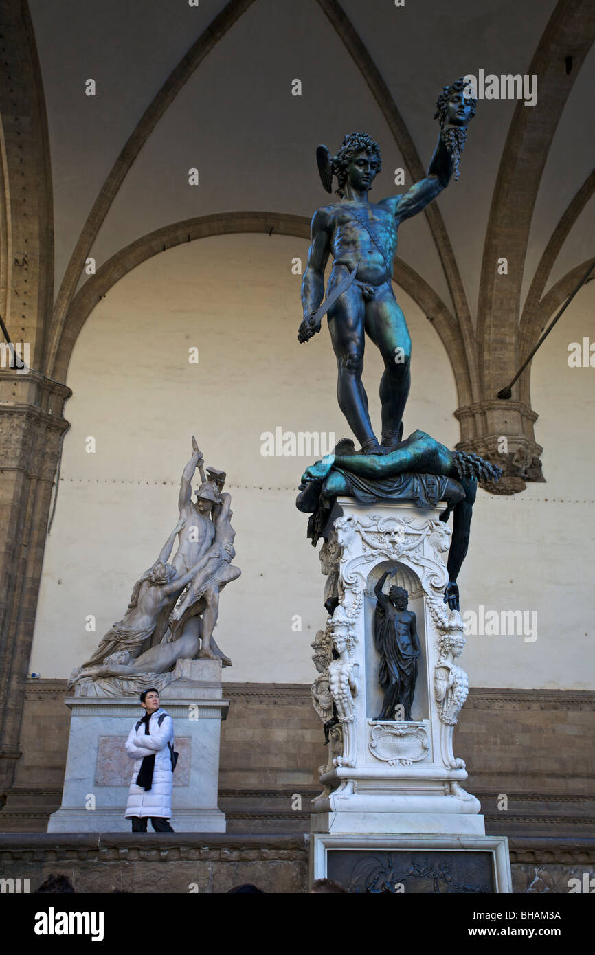 A tourist admires the statues in Piazza Della Signoria, Florence, Italy ...