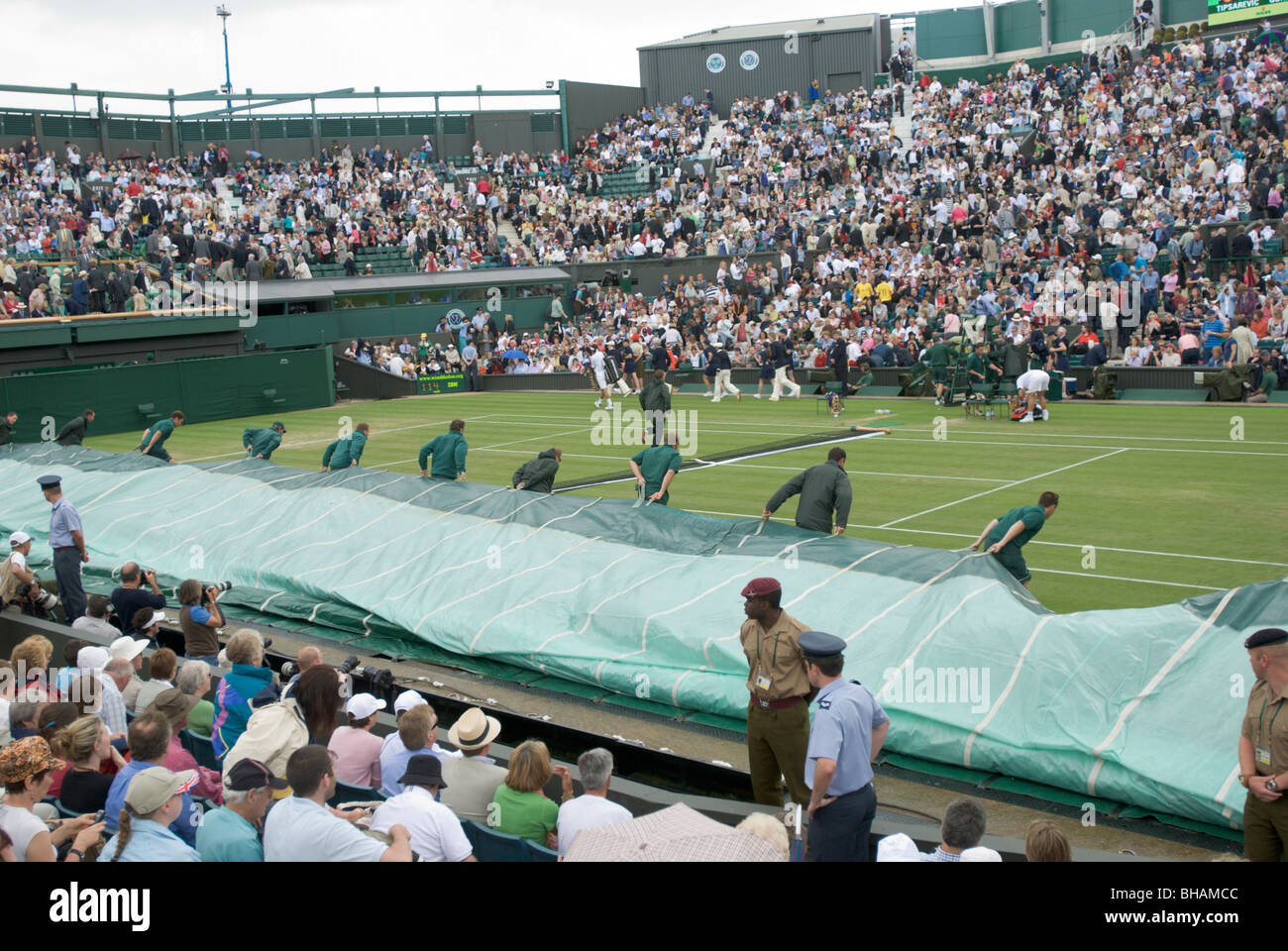 Centre court covers are deployed to cover the playing surface ...