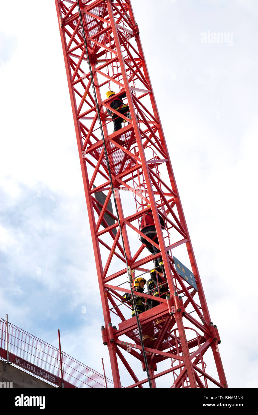 firemen climbing a tower crane Stock Photo - Alamy