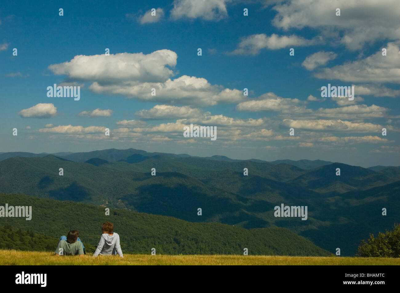 Young man and woman enjoy the view from Waterrock Knob on the Blue ...