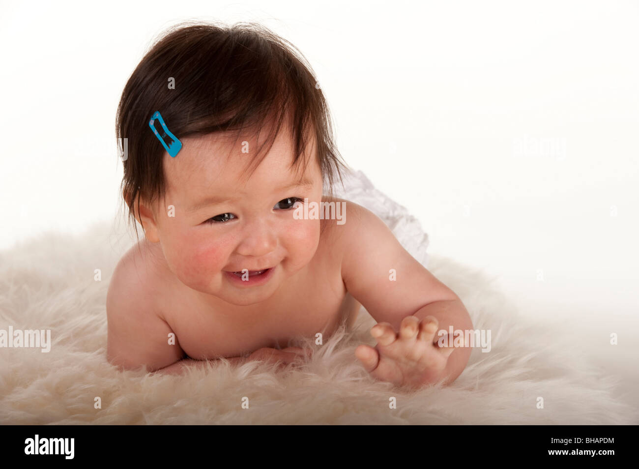 Pacific Islander baby girl smiling as learning to crawl Stock Photo - Alamy