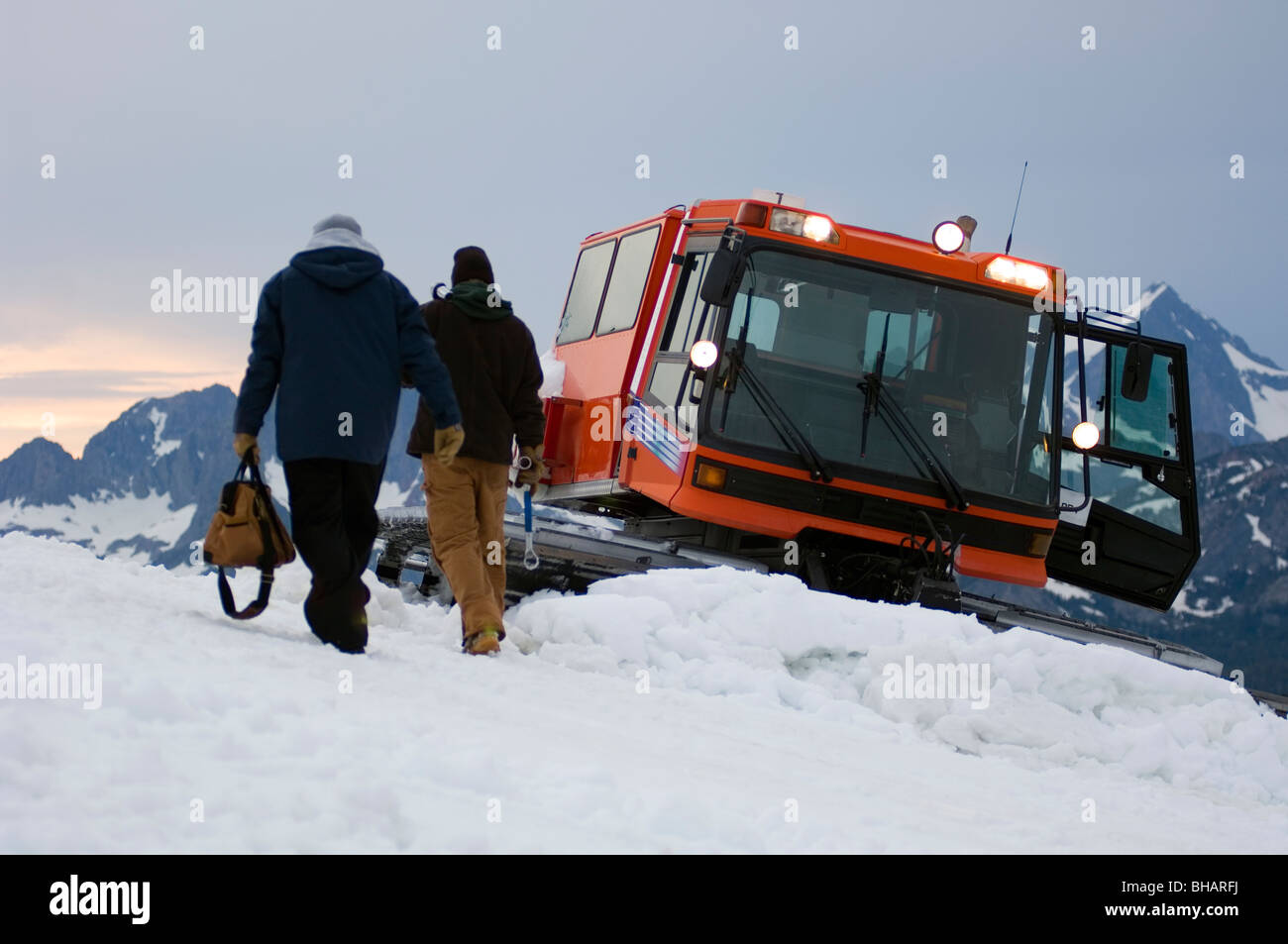 ski resort workers working around a snow grooming machine Stock Photo ...