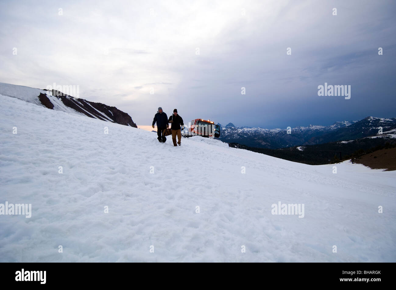 ski resort workers working around a snow grooming machine Stock Photo ...