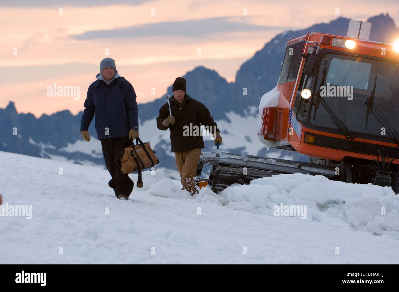 ski resort workers working around a snow grooming machine Stock Photo ...