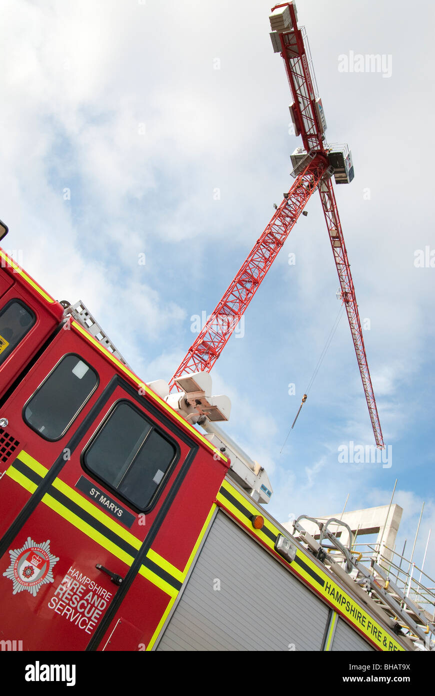 Fire engine on construction site with tower crane Stock Photo - Alamy