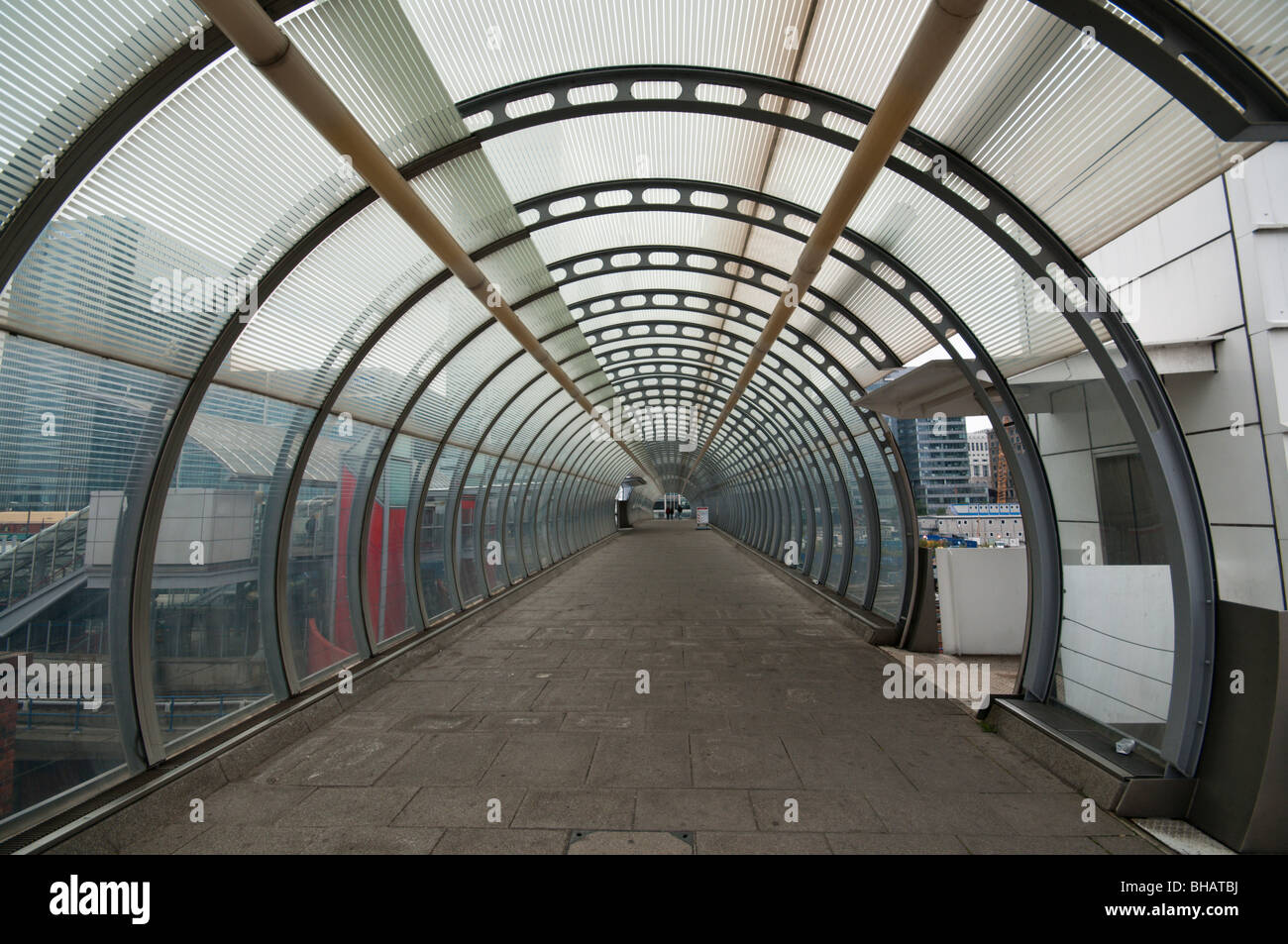 Footbridge at Poplar DLR station, London is enclosed in a slightly ...