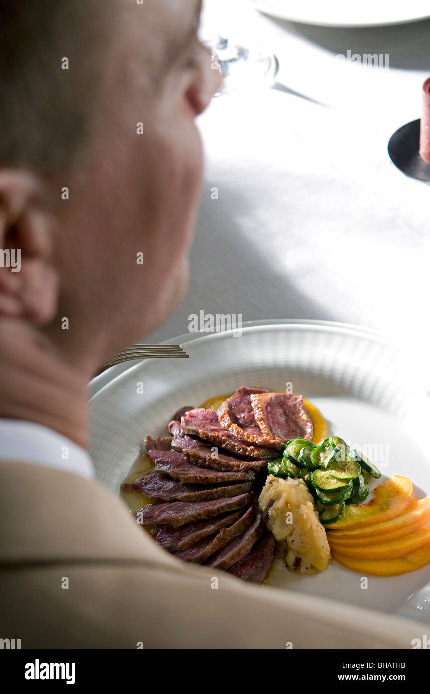 Young man with plate of food at restaurant Stock Photo - Alamy