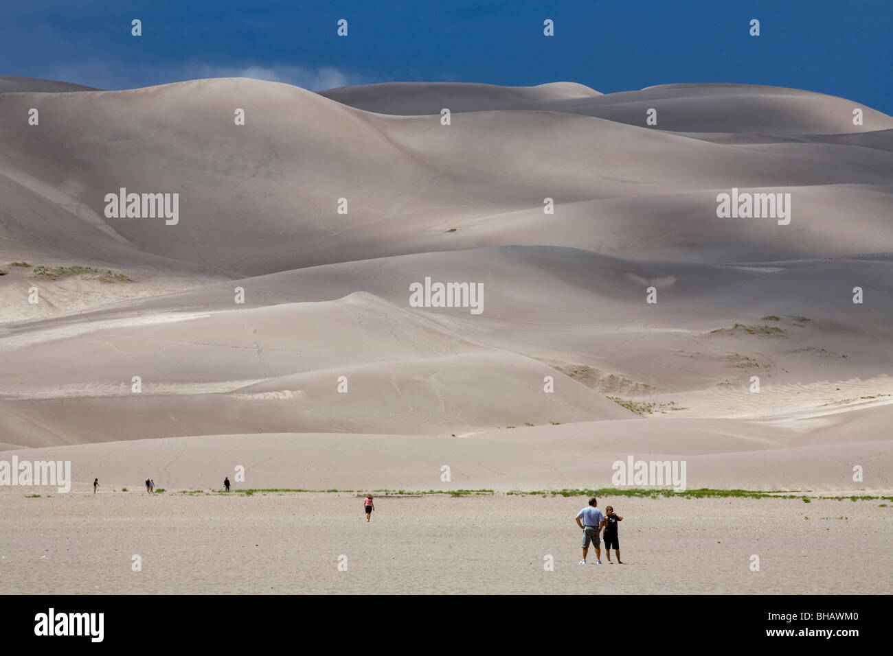 Visitors head towards the base of High Dune in Great Sand Dunes ...