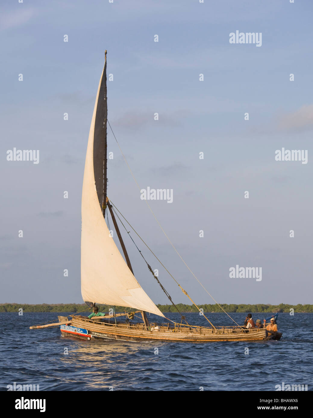 A traditional dhow boat sailing off the coast of Lamu, Kenya, East ...