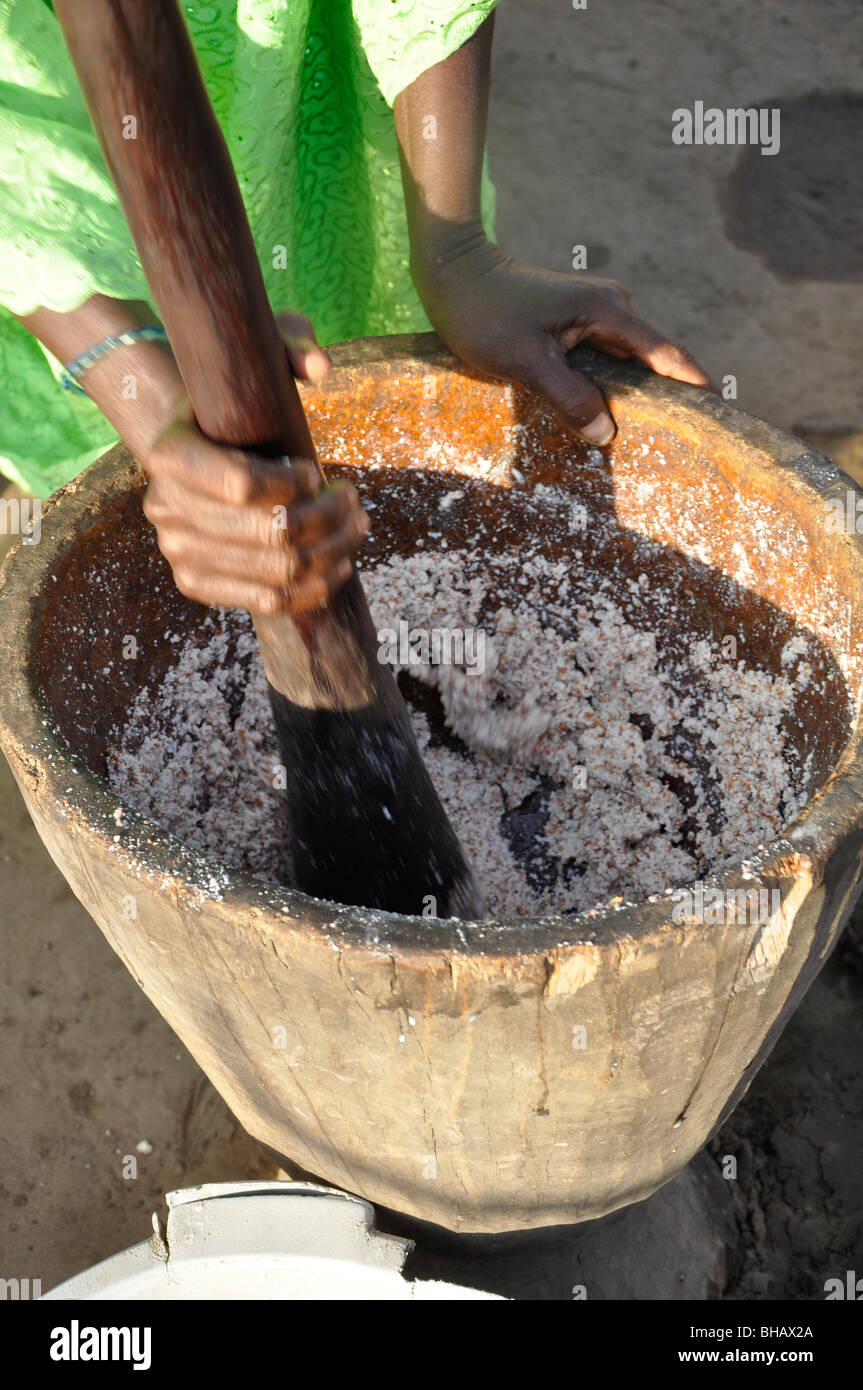 Grinding of peanuts in a mortel, The Gambia Stock Photo - Alamy