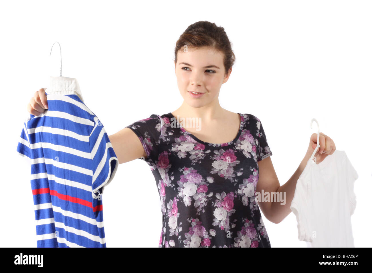 A teenage girl choosing which clothes to wear Stock Photo - Alamy