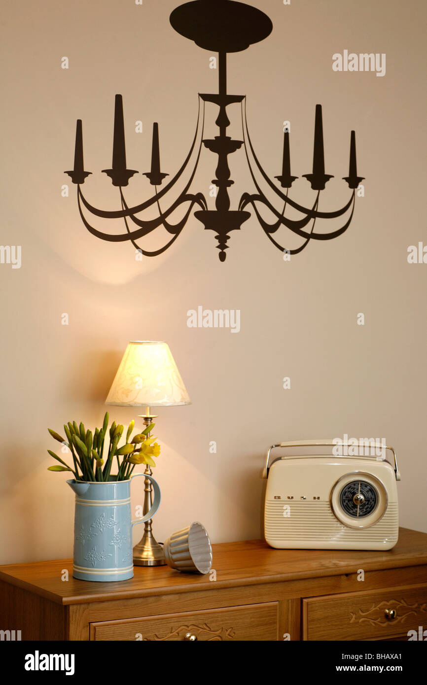 Sideboard with flowers, lamp and radio Stock Photo - Alamy