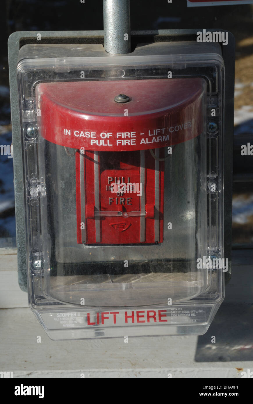 A wall mounted pull-type fire alarm enclosed in a plastic case Stock ...