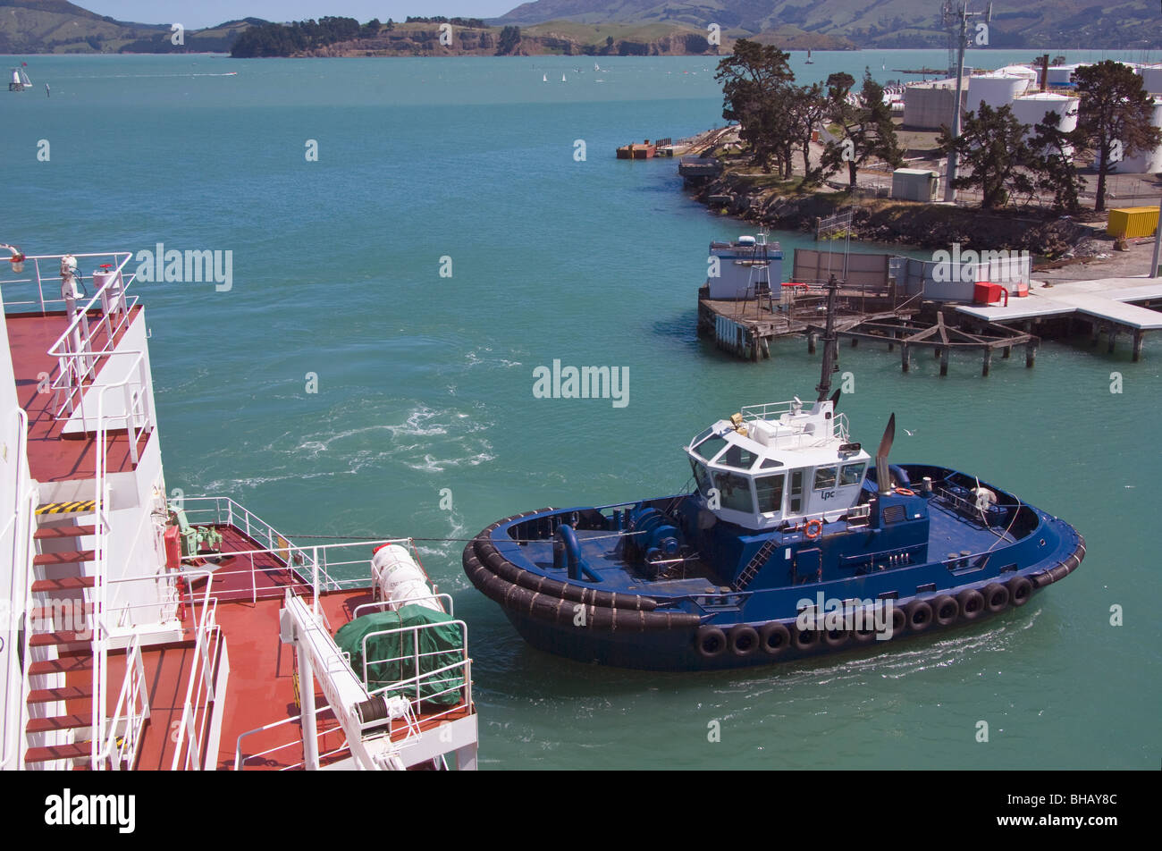 A tug helps a ship to manoeuvre in a cofined area prior to arriving at ...