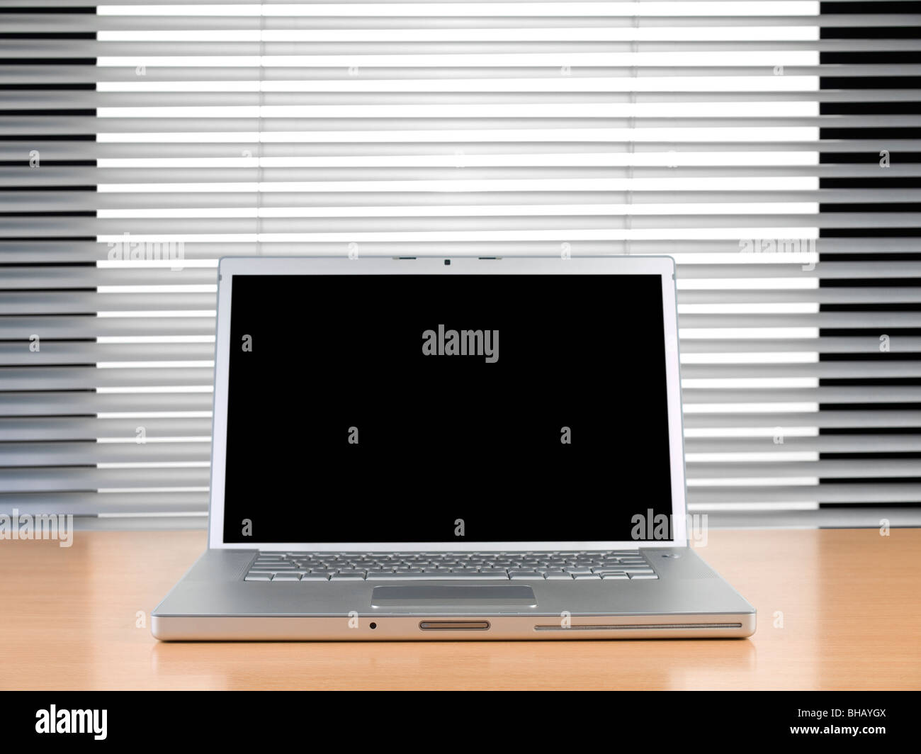 A laptop on a table at a modern office Stock Photo - Alamy