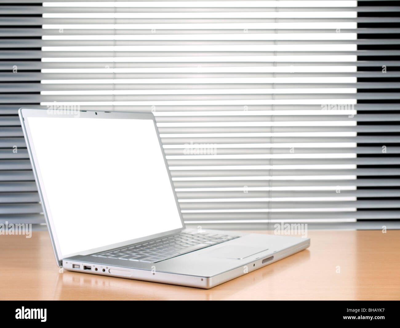 A laptop on a table at a modern office Stock Photo - Alamy