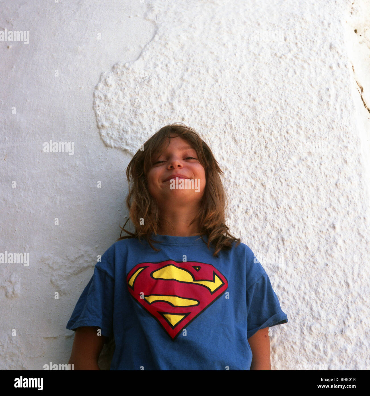 young girl in front of a white wall pulling faces Stock Photo - Alamy