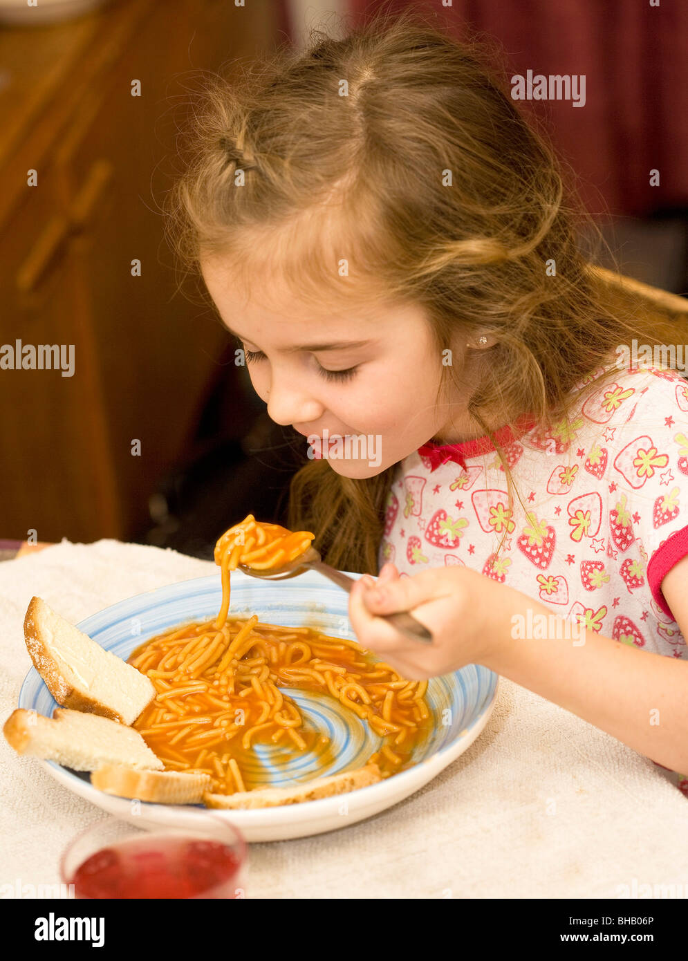 A girl eating spaghetti Stock Photo - Alamy