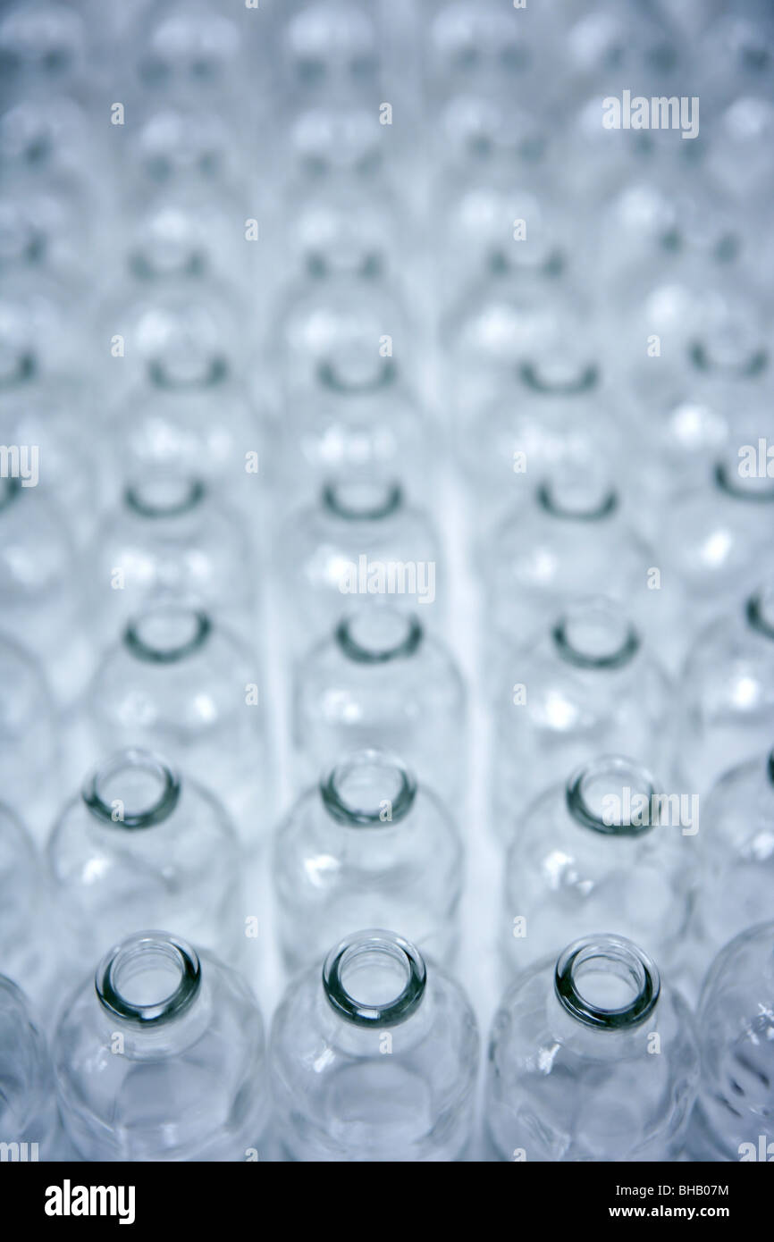 Glass transparent empty bottles in rows, cosmetics assembly line Stock ...
