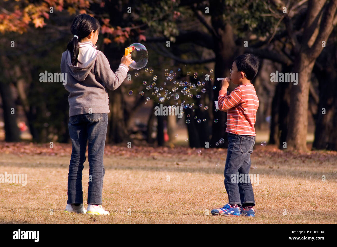 Kids having fun with soap bubbles Stock Photo - Alamy