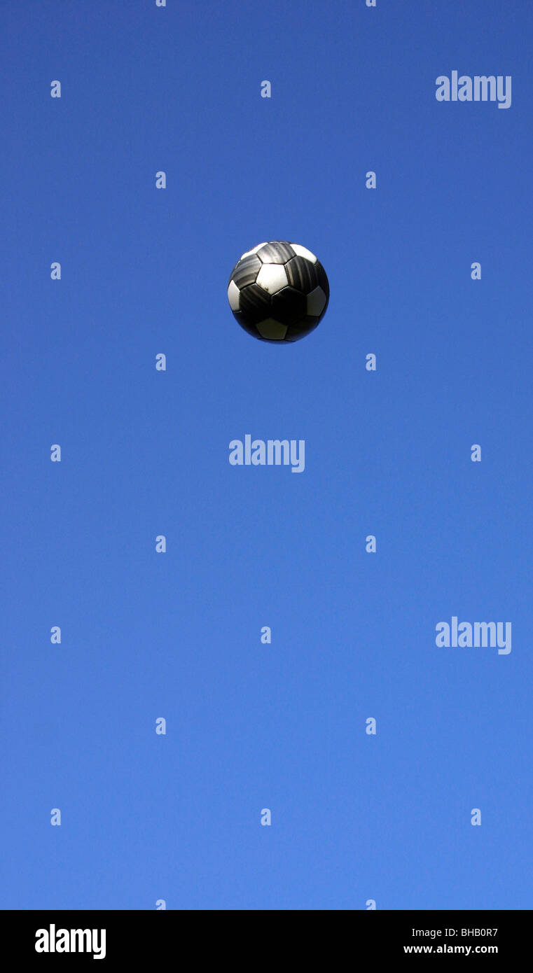 Football flies through the air at game Stock Photo - Alamy