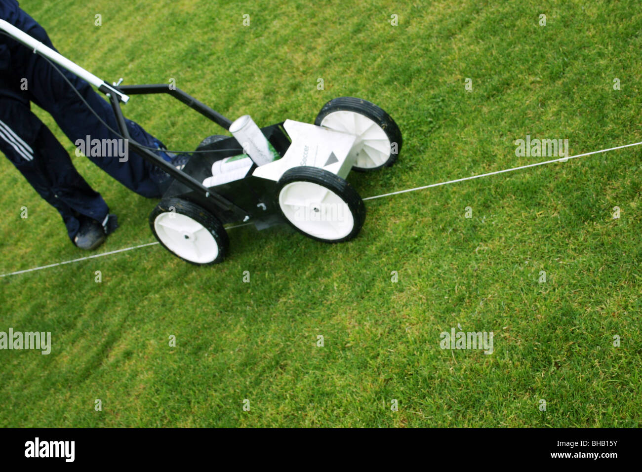 Player uses lining machine to line the pitch before a game Stock Photo ...