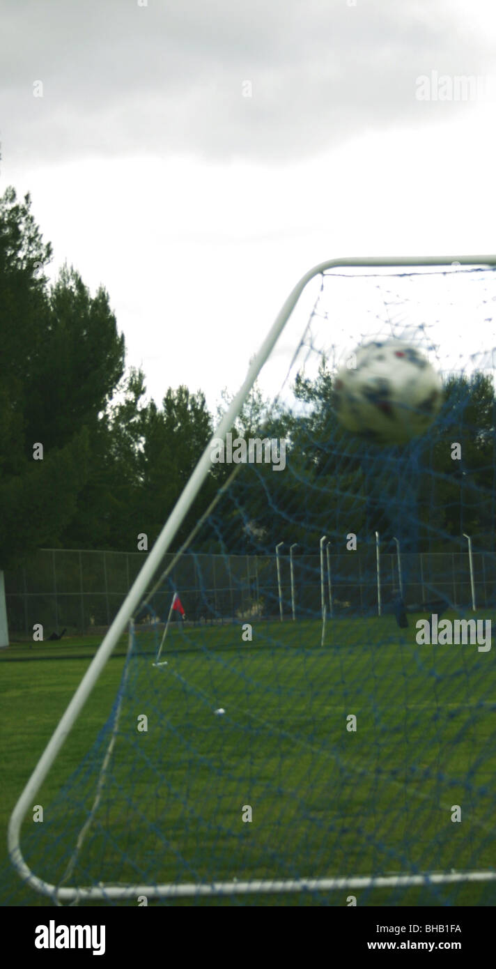 Football flies into top corner of goal during a game Stock Photo - Alamy