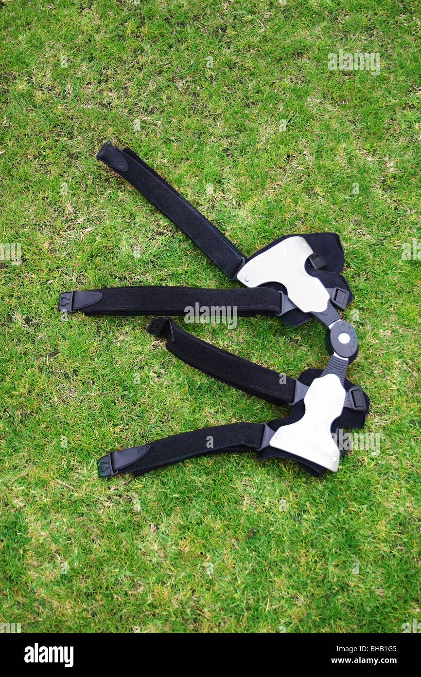 Footballers knee brace lies in grass after a game Stock Photo - Alamy